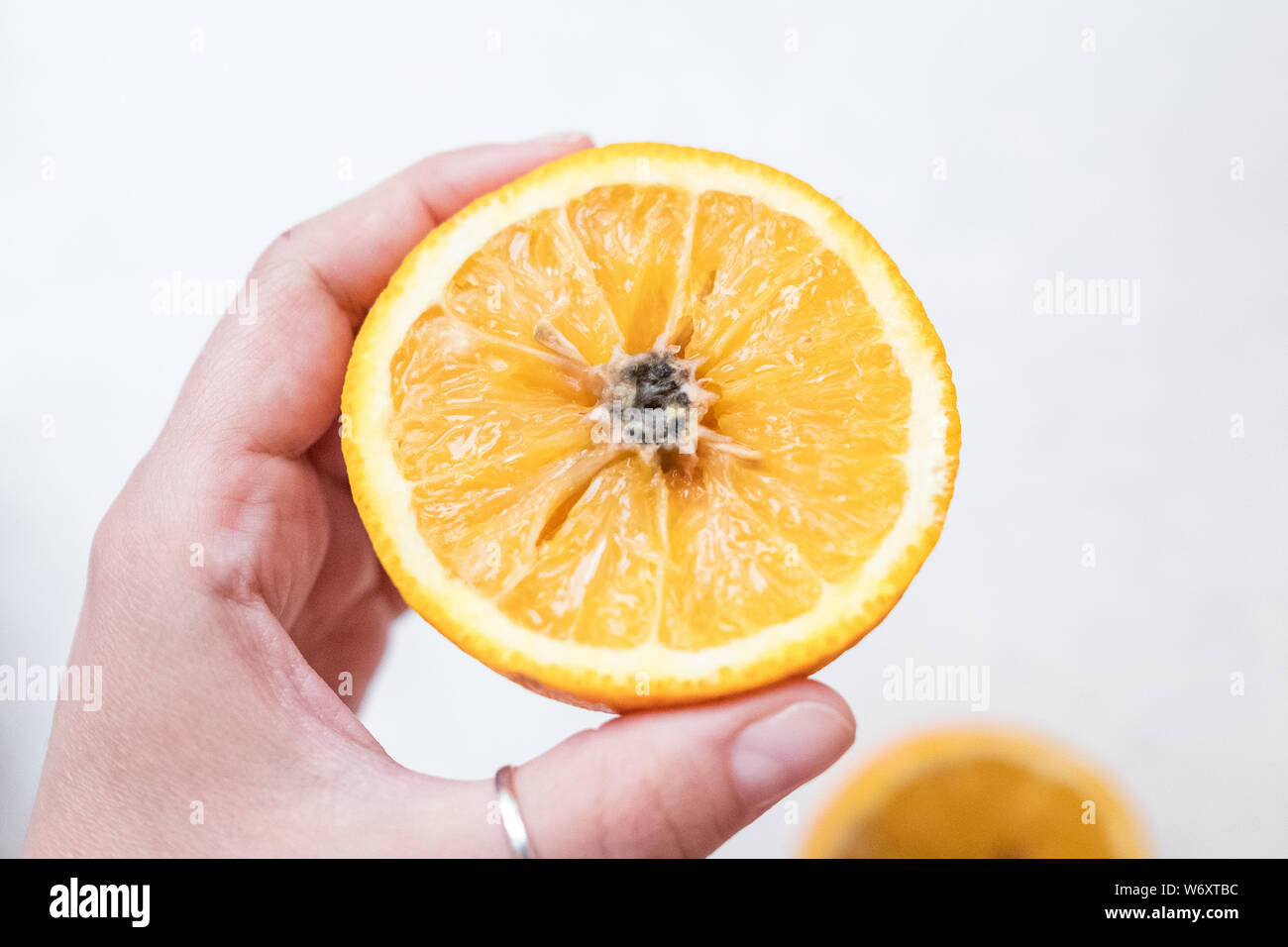 Spoiled orange. The black middle inside the fruit Stock Photo - Alamy