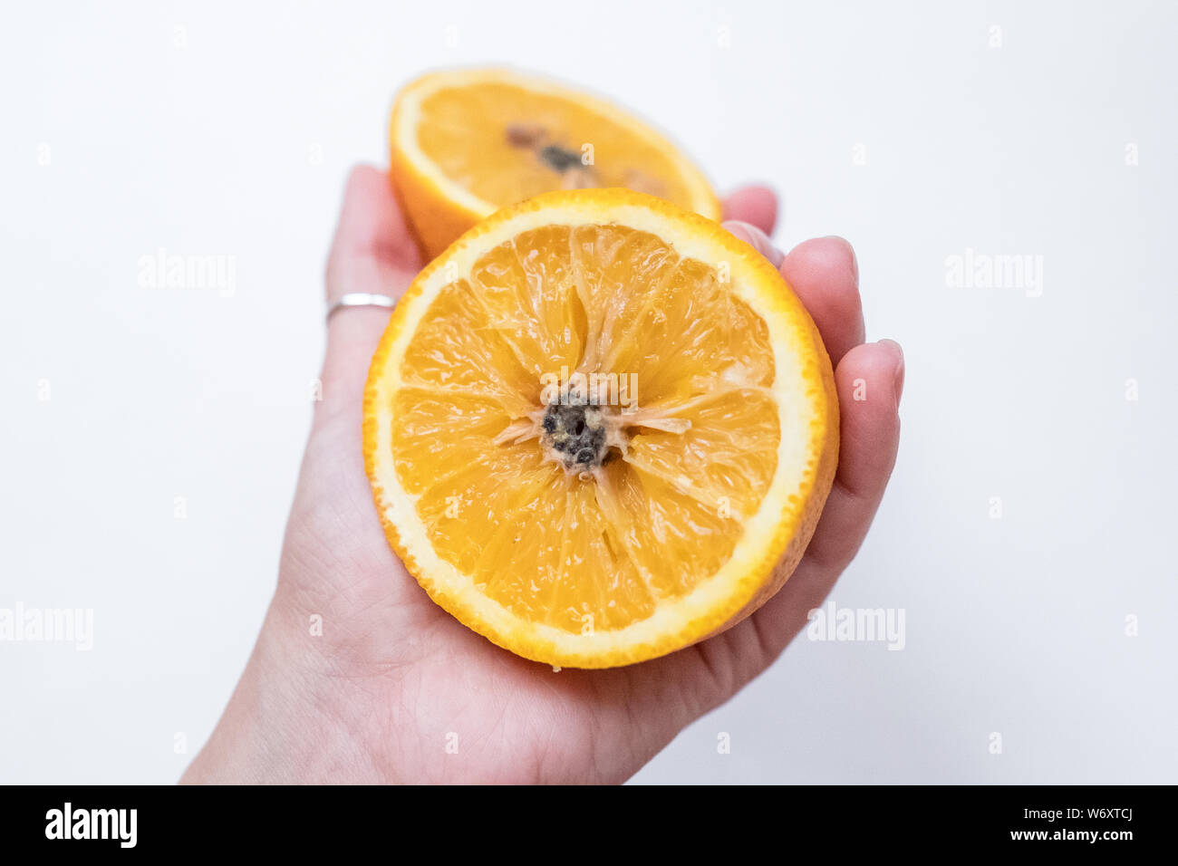Spoiled orange. The black middle inside the fruit Stock Photo - Alamy