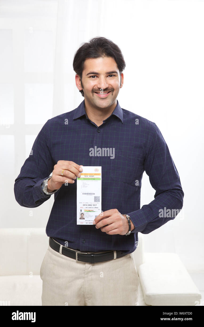 Portrait of a man showing an Aadhar card Stock Photo - Alamy