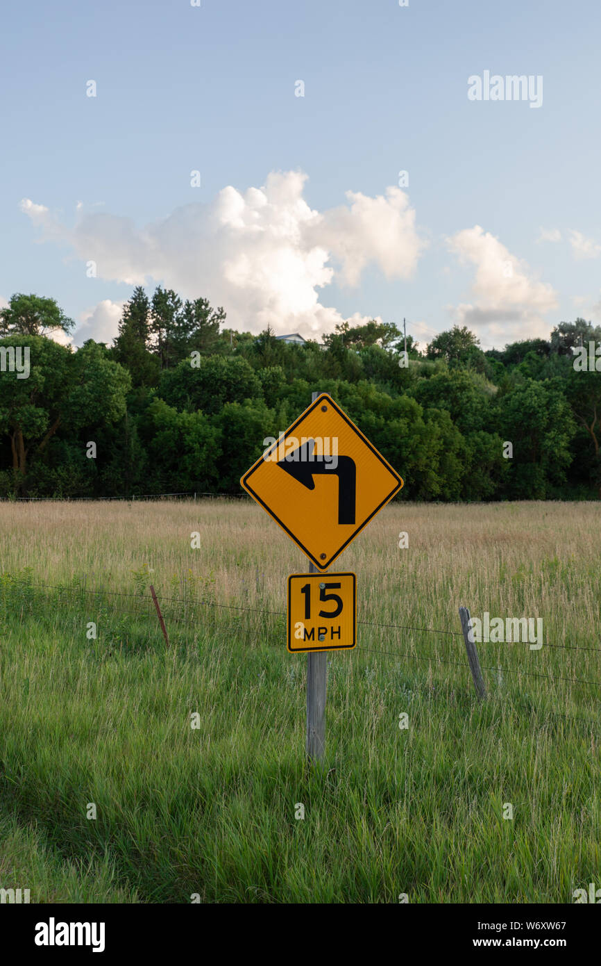 Landscape photo of a field in the midwest with fluffy clouds and a turn ...