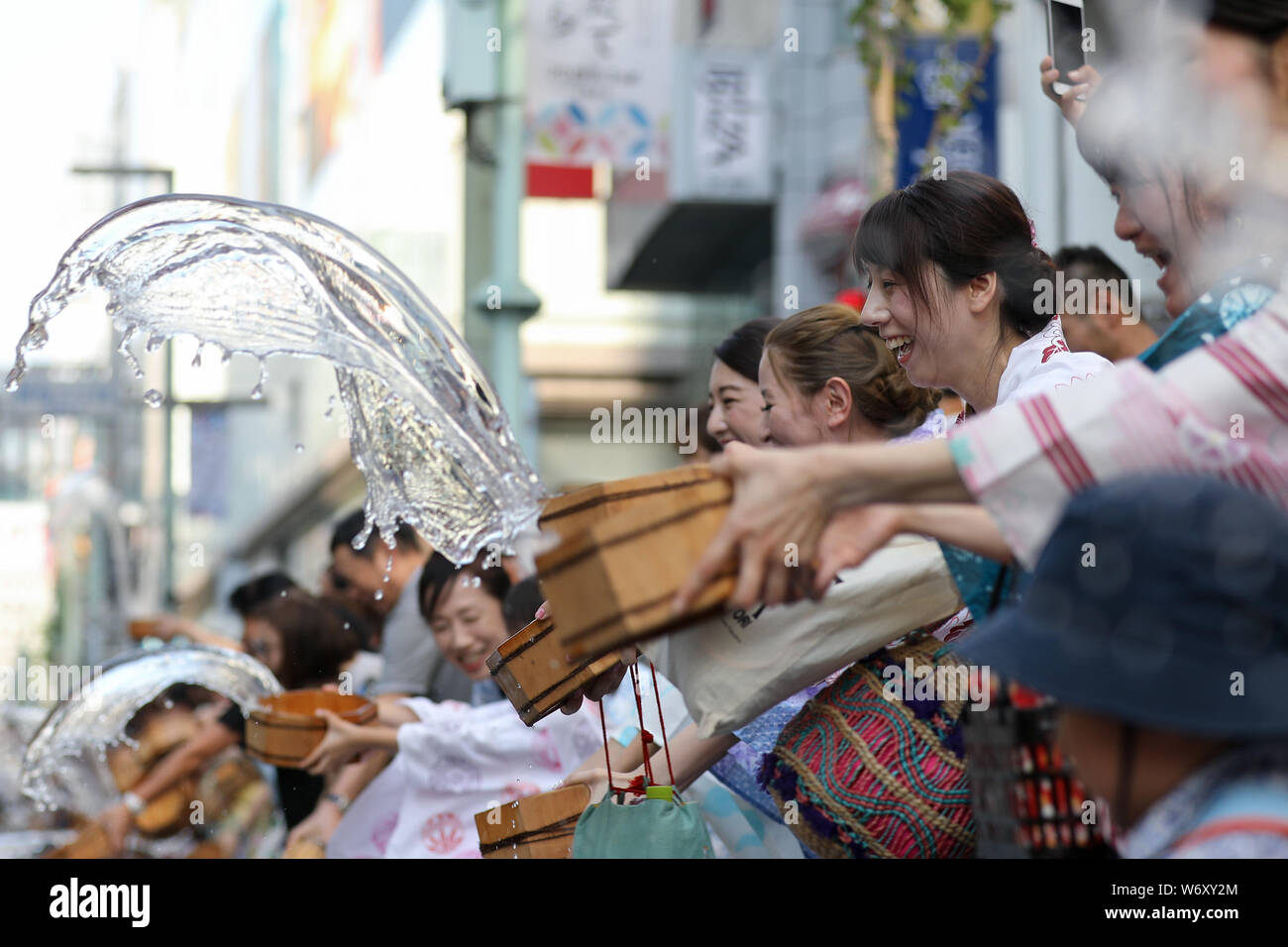 Tokyo, Japan. 3rd Aug, 2019. People in traditional costumes splash ...