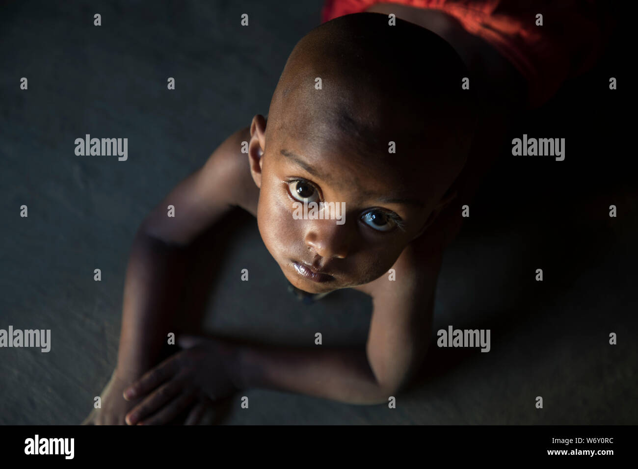 Smiling face portrait of a young child or young boy from rural part of ...