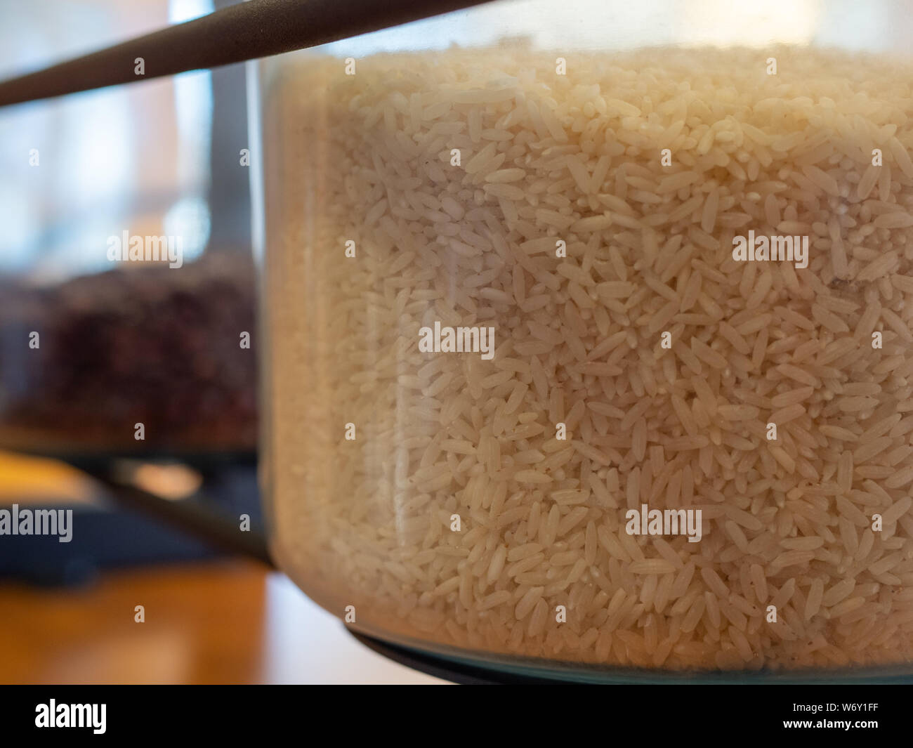 Dried white rice sitting in large glass jar sitting on shelf Stock ...