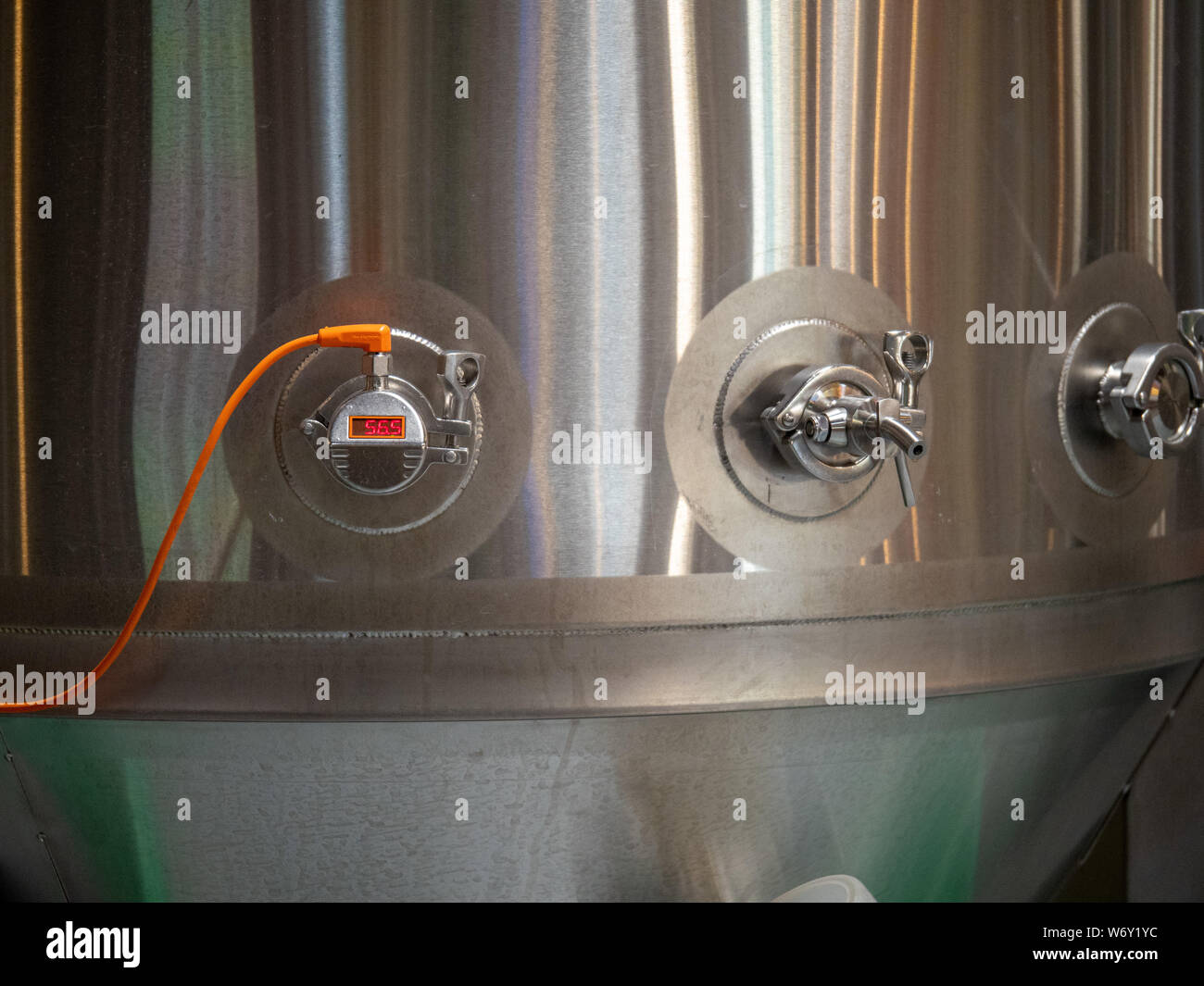 Tubes running into large steel fermentation tank in brewery Stock Photo ...