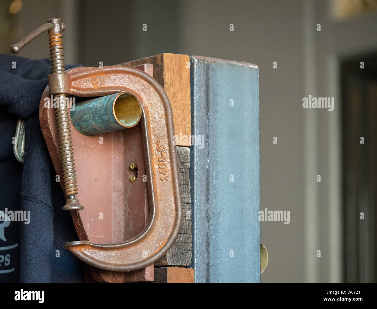 1460-6 c-clamp tool manufacturing factory resting on industrial wall ...