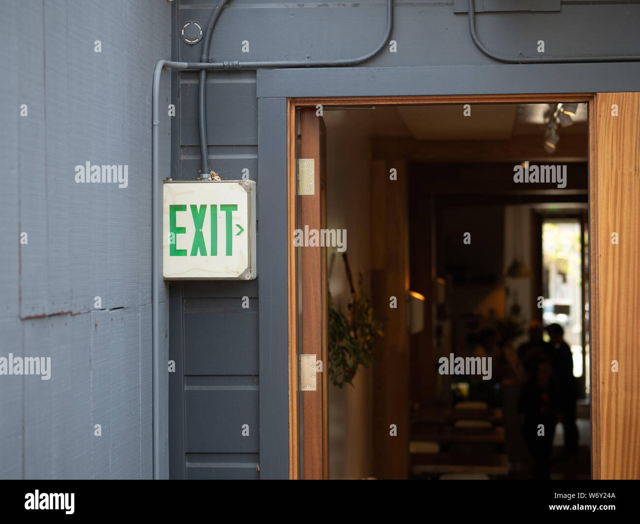 Outdoor green exit sign leading to inside building restaurant Stock ...