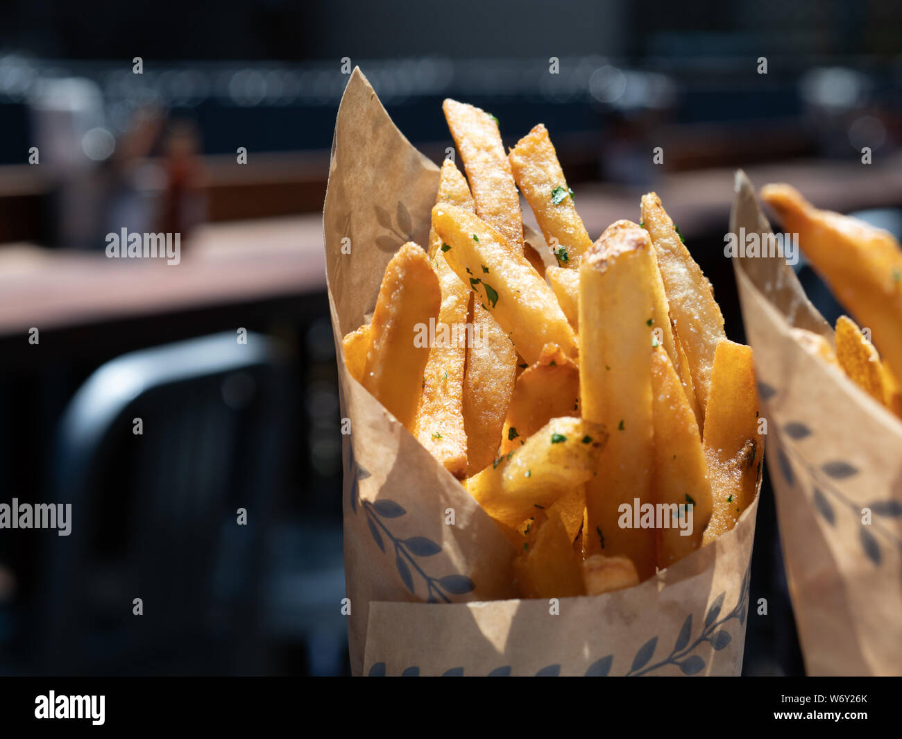 Gourmet french fries deep fried and piled into steel cup with wrapper ...