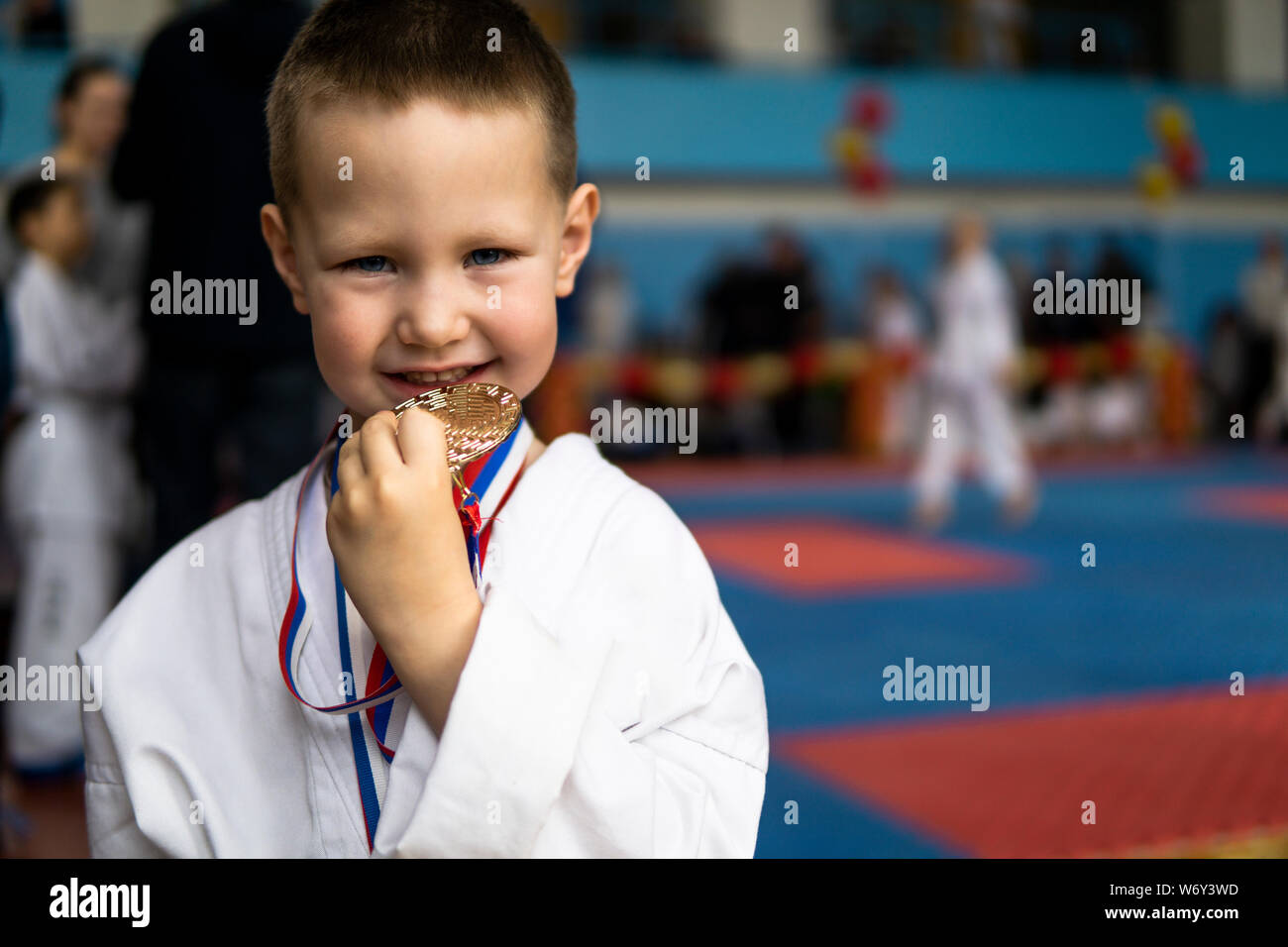 Sport success and win concept - smiling athlete champion child boy hand ...
