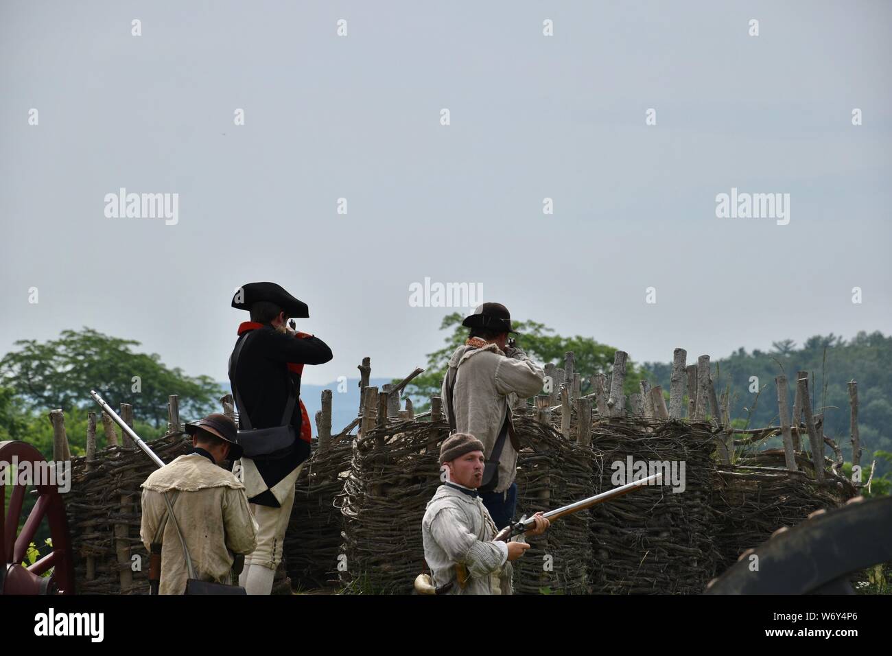 Reenactors reenacting British soldiers and American colonists during ...