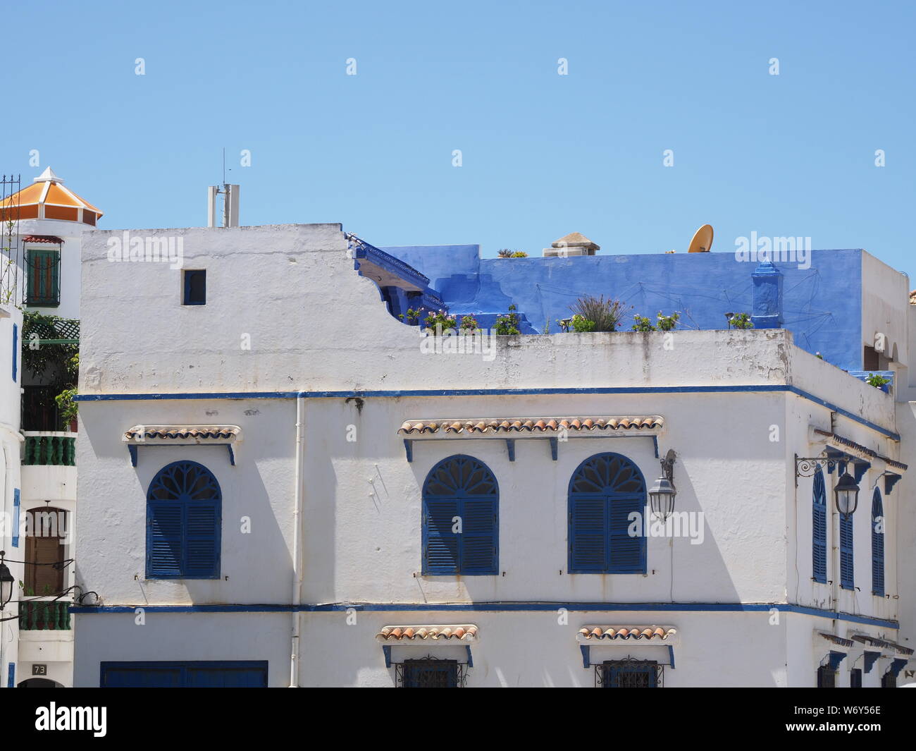 Arabic white building with blue windows in african medina of Asilah ...
