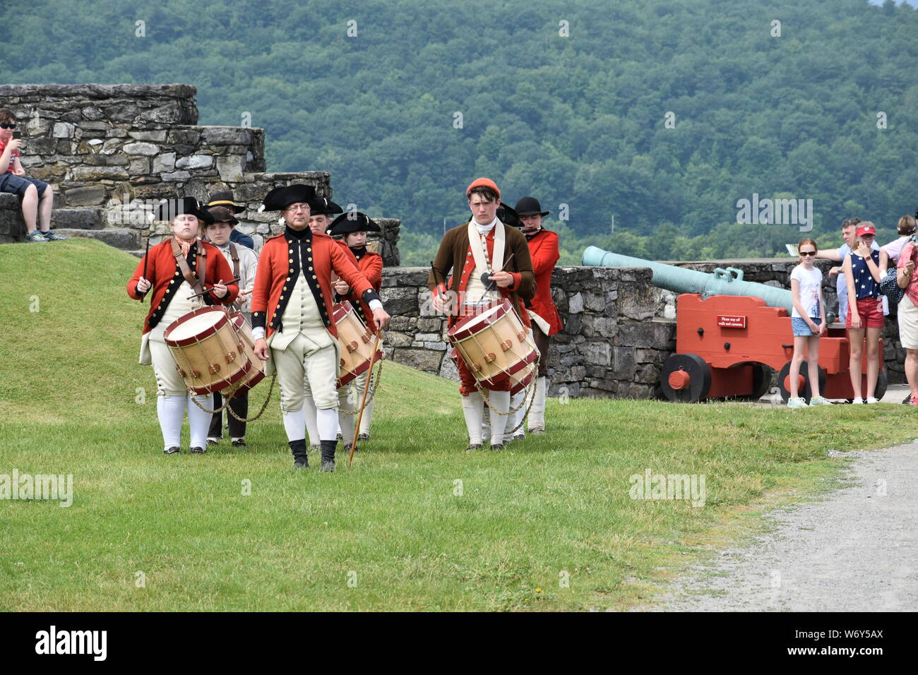 Reenactors reenacting British soldiers and American colonists during ...