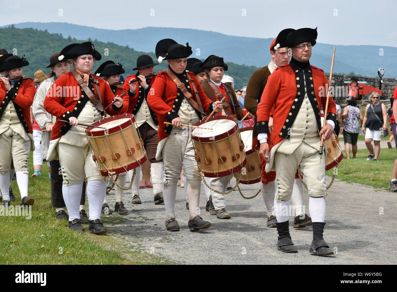 Reenactors reenacting British soldiers and American colonists during ...
