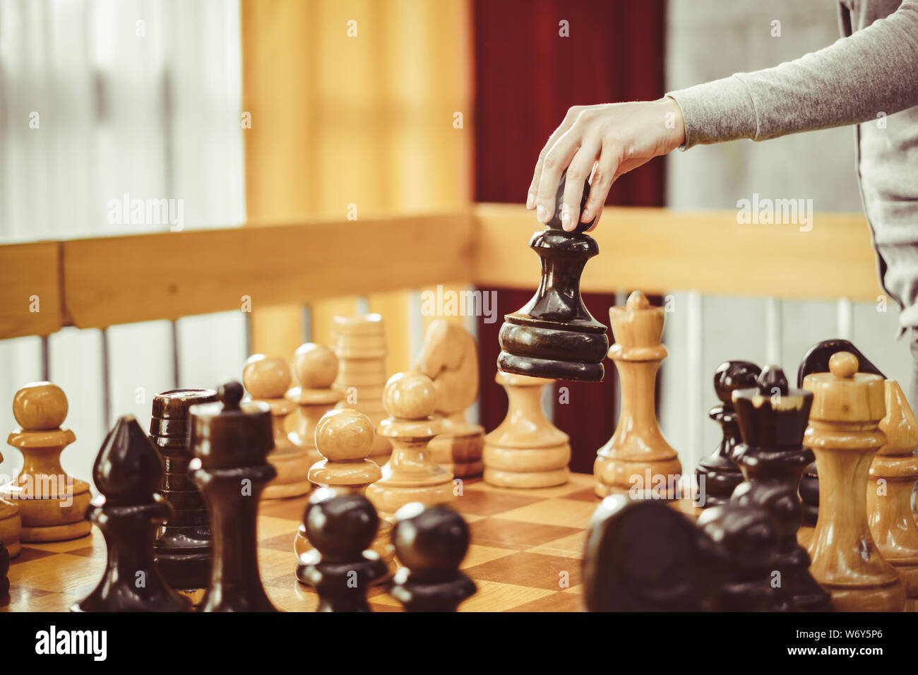 hand holding a large chess piece over the Board Stock Photo - Alamy