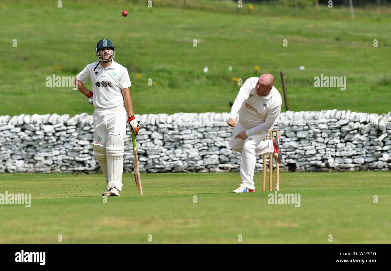 A slow bowler in action in the match between Old Glossop and Tintwistle ...