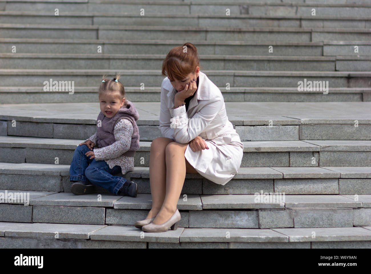 Child and mother sitting on stairs Stock Photo - Alamy