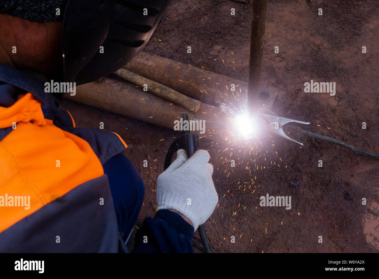 Operator welding steel construction. Industrial worker during welding ...