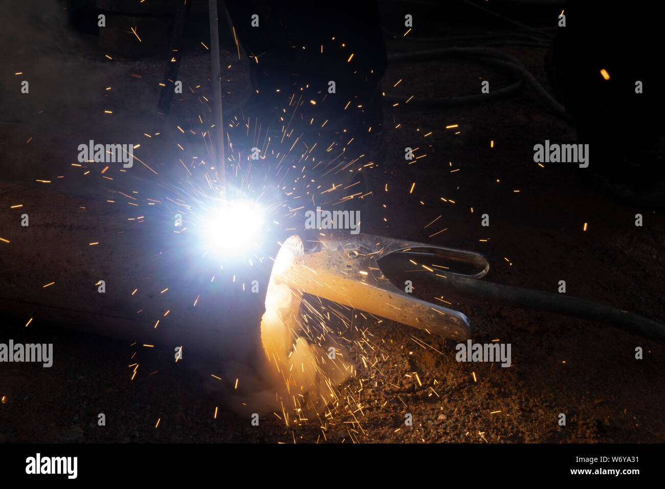 Operator welding steel construction. Industrial worker during welding ...