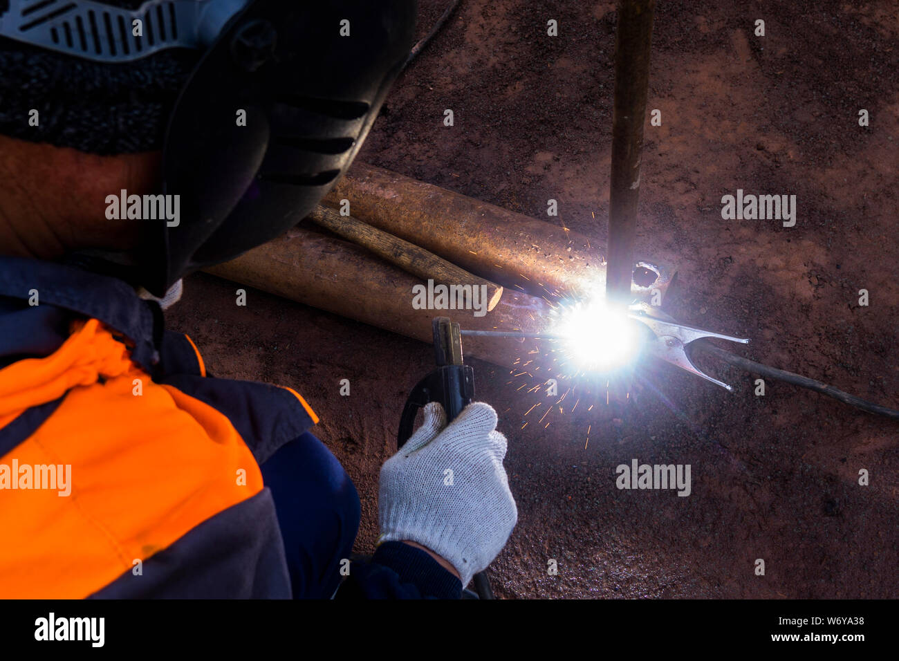 Operator welding steel construction. Industrial worker during welding ...