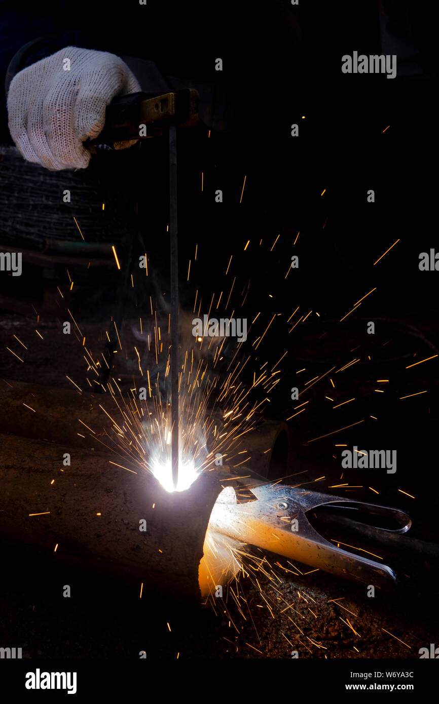 Operator welding steel construction. Industrial worker during welding ...