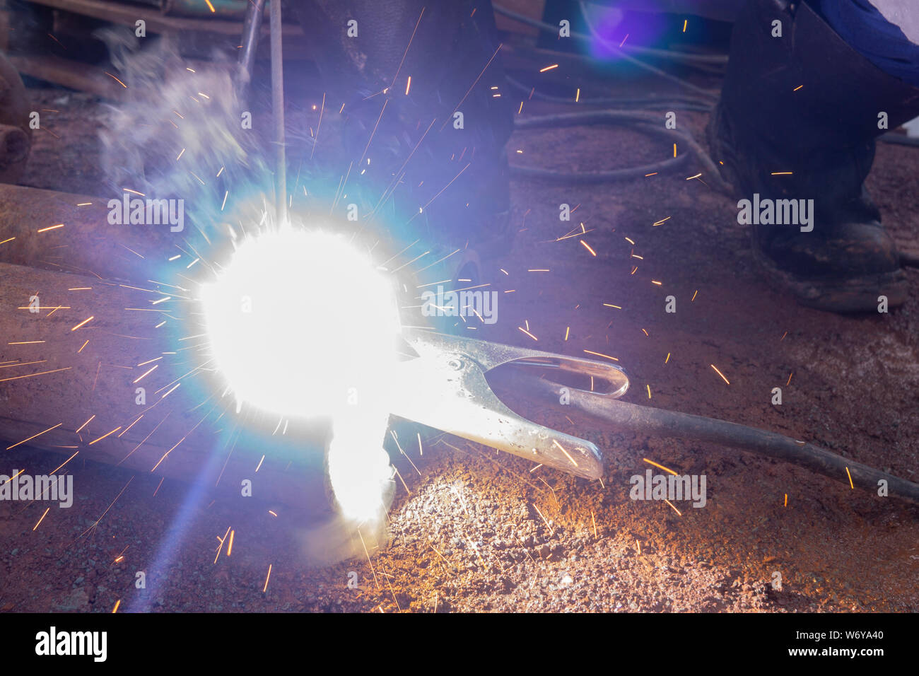 Operator welding steel construction. Industrial worker during welding ...