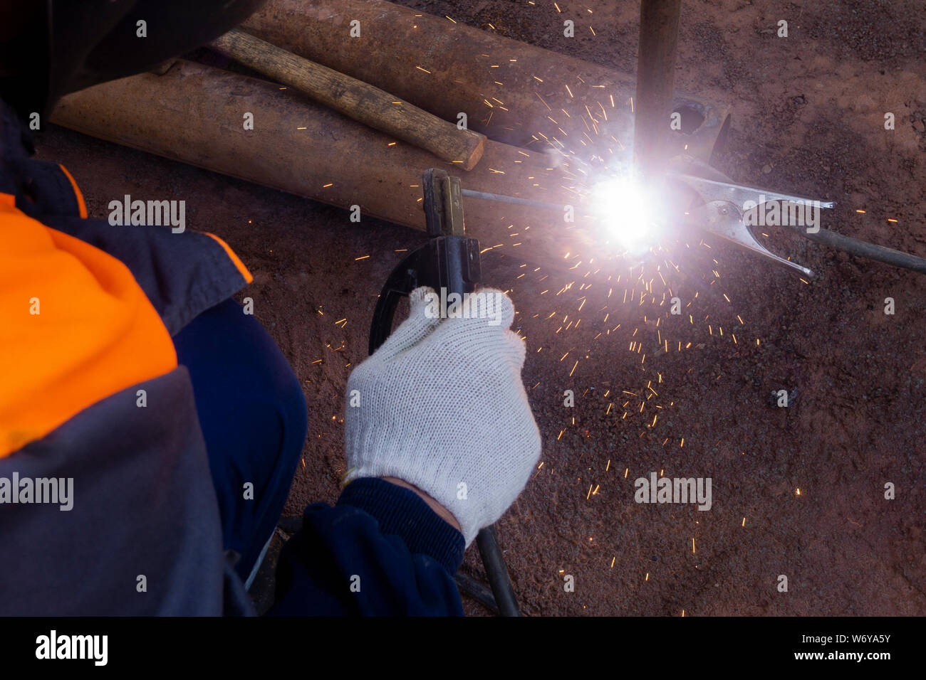Operator welding steel construction. Industrial worker during welding ...