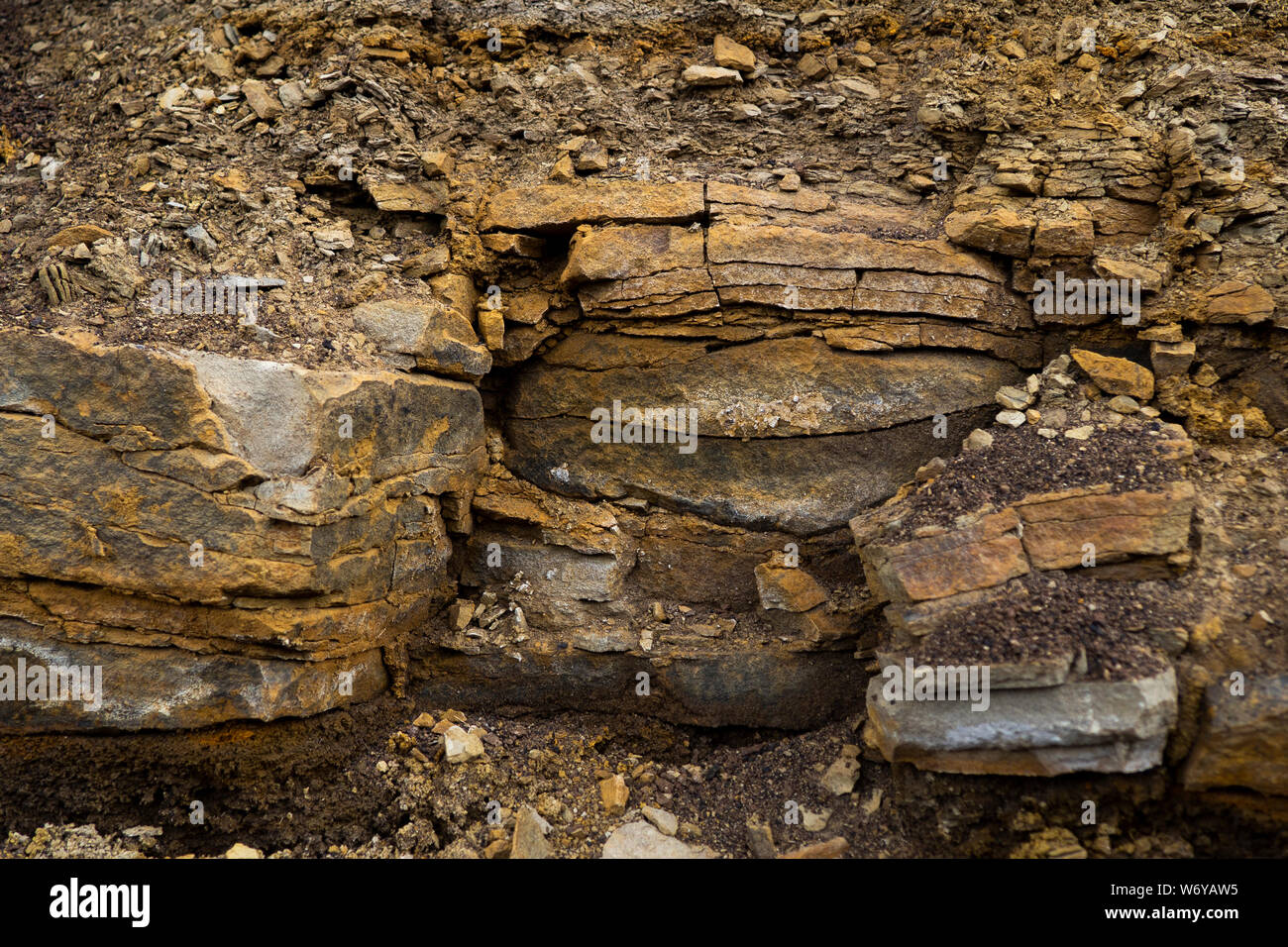 Soil cut-sandstone, stones, clay, sand structure and layers. slice of ...