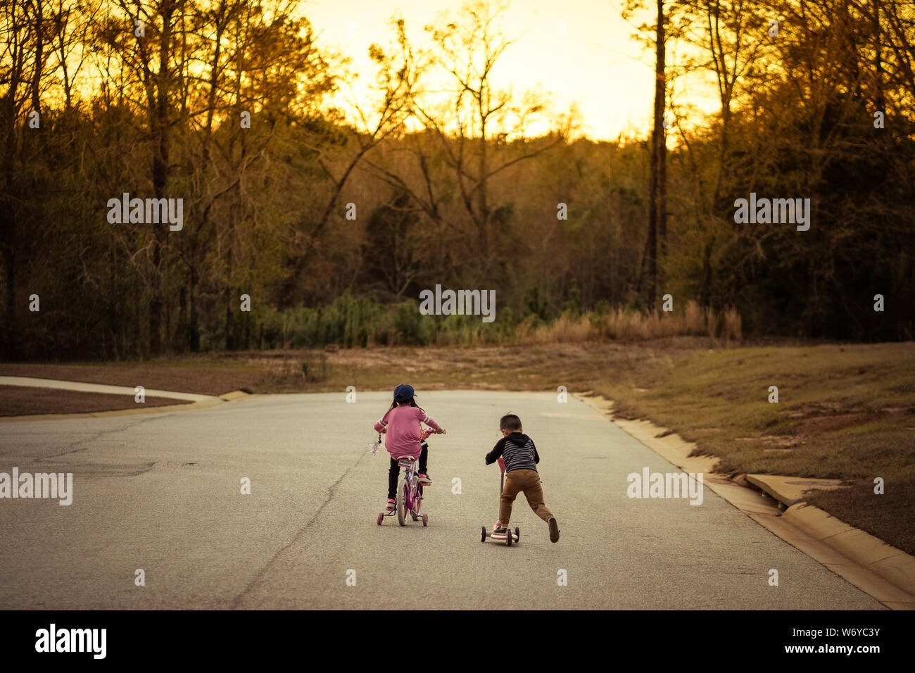 Family fun, riding into the sunset Stock Photo - Alamy