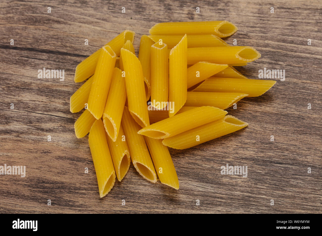 Raw penne pasta ready for bowl Stock Photo - Alamy