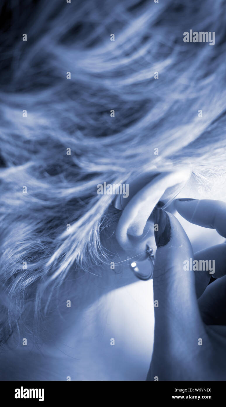 Deaf lady with modern technology digital hearing aid in her ear Stock ...