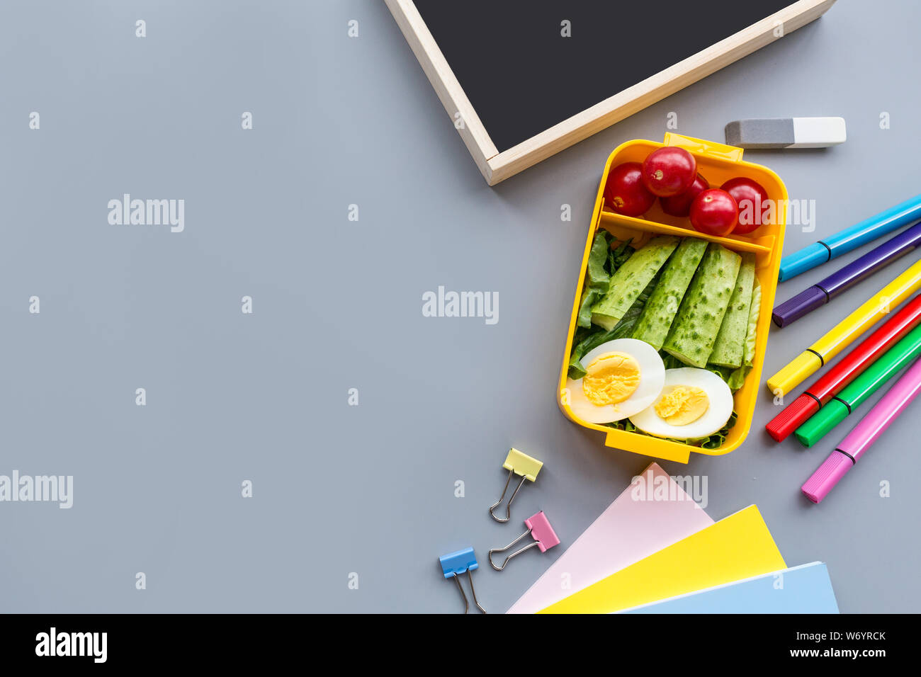 School supplies and lunch box with sandwich and vegetables. Back to ...