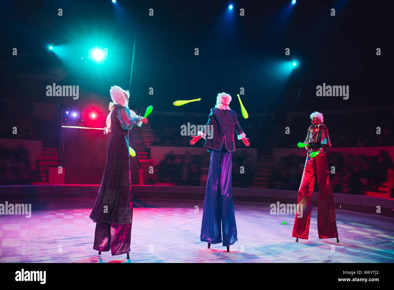 The performance of stilt-walkers in the circus Stock Photo - Alamy