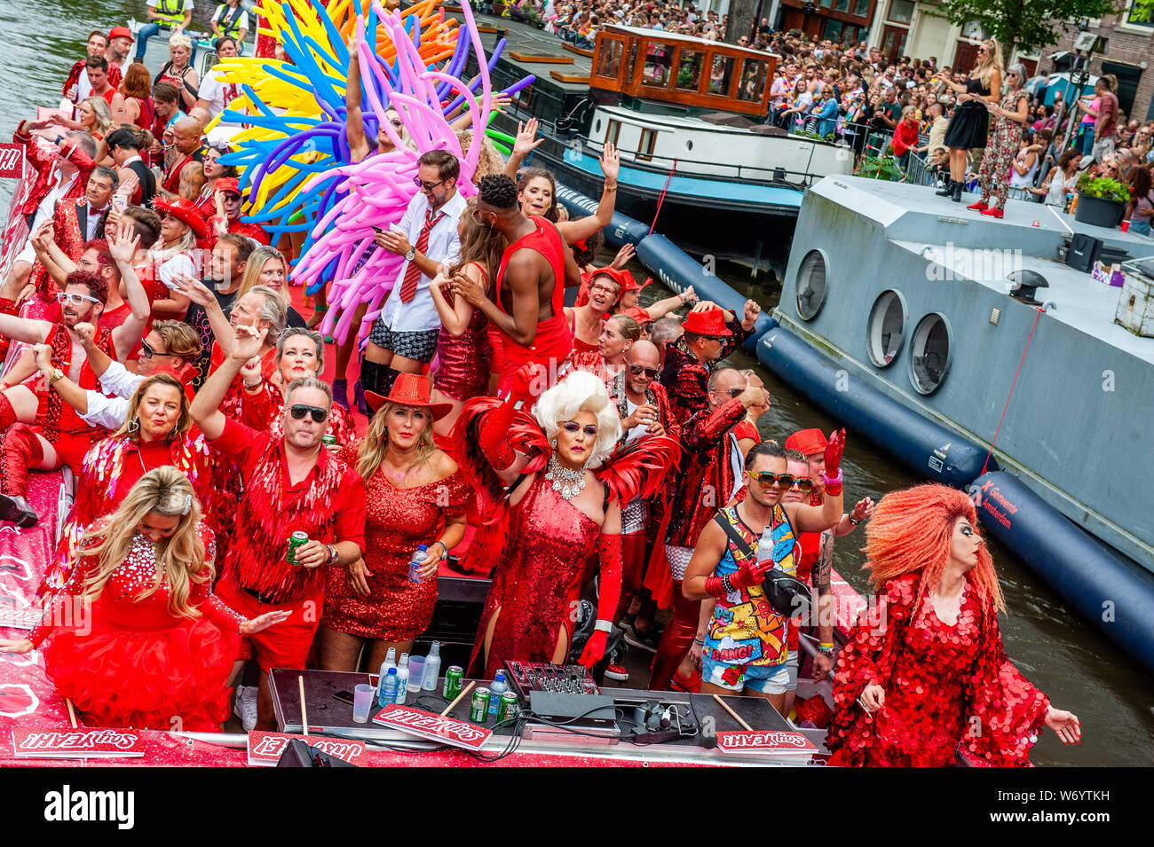 Drag queens wearing red costumes are seen on board of a boat during the ...