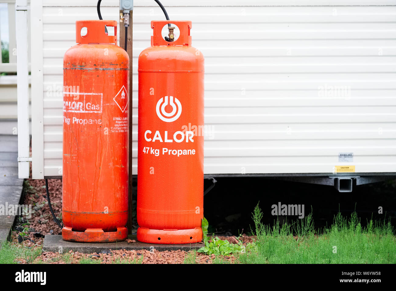Calor gas cylinder bottles refilling with hose at refill point within ...