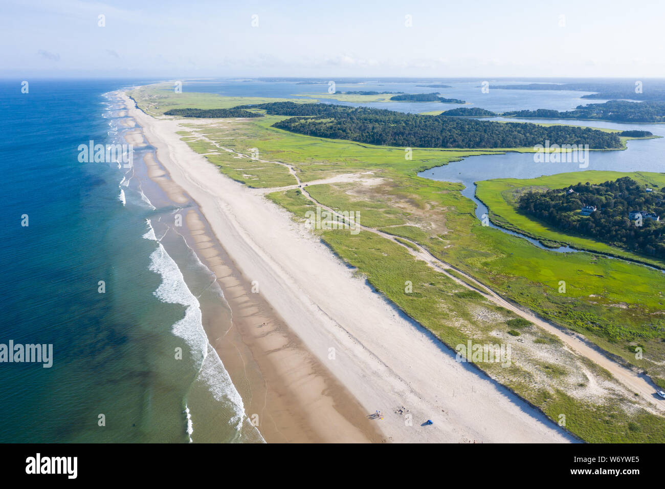 The cold waters of the Atlantic Ocean bathe a scenic beach on Cape Cod ...