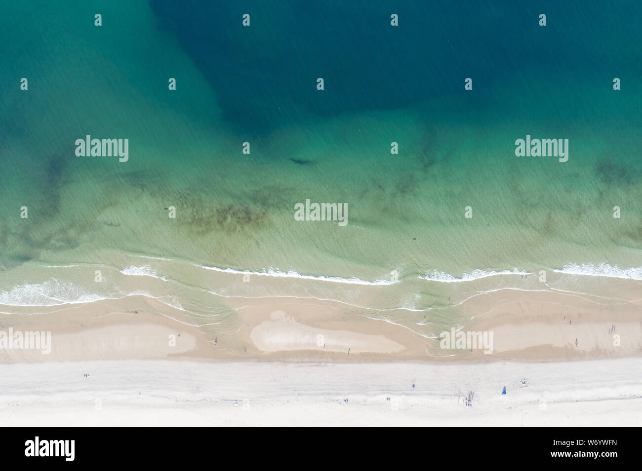 The cold waters of the Atlantic Ocean bathe a scenic beach on Cape Cod ...