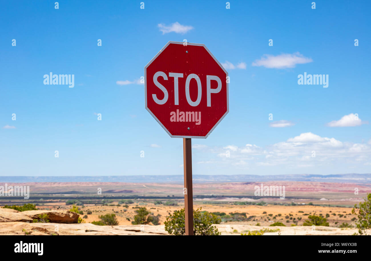 Stop road sign, blur desert landscape, US. Red sandstone rock ...