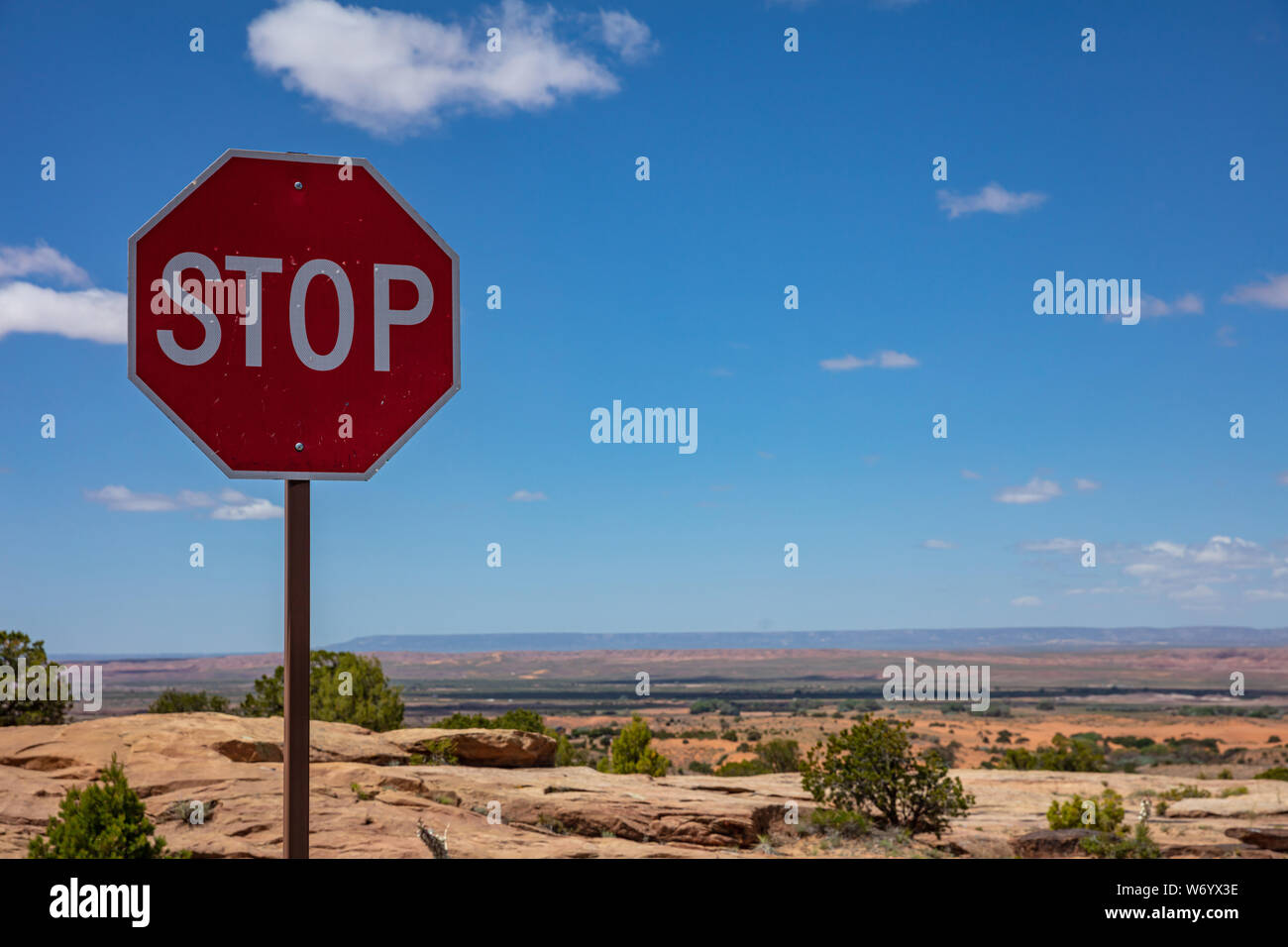 Stop road sign, blur desert landscape, US. Red sandstone rock ...