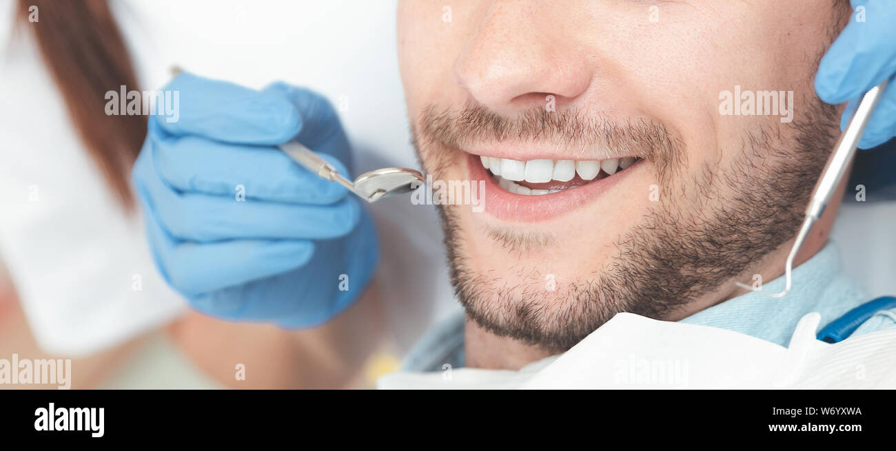 Young man at the dentist. Dental care, treatment of teeth, taking care ...