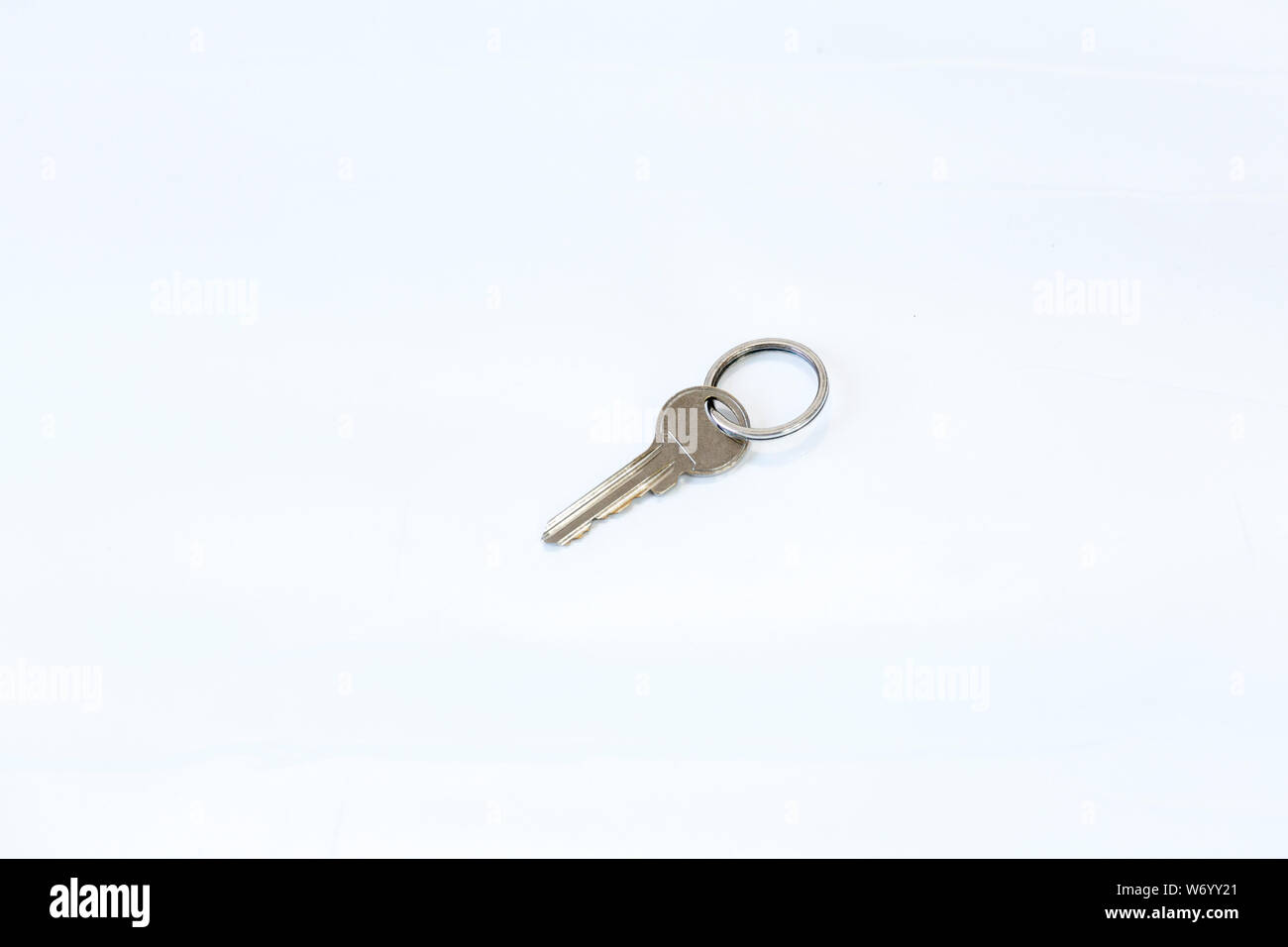 metal key on white ground Stock Photo - Alamy