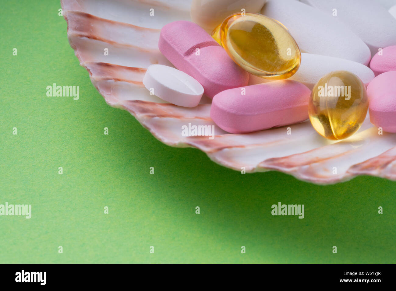 colored pills and multivitamins on a green background. omega3 Stock ...