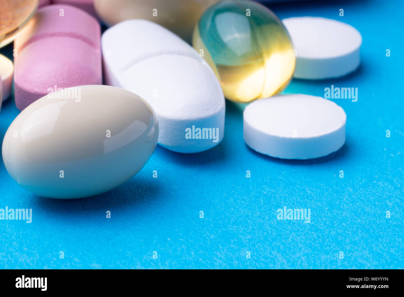 colored pills and multivitamins on a blue background. omega3 Stock ...