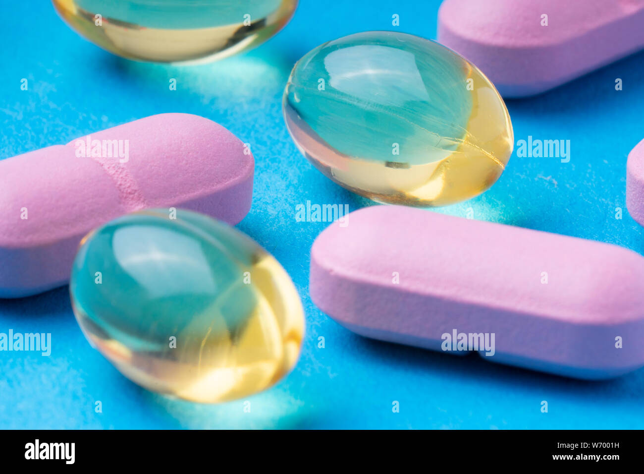 colored pills and multivitamins on a blue background. omega3 Stock ...