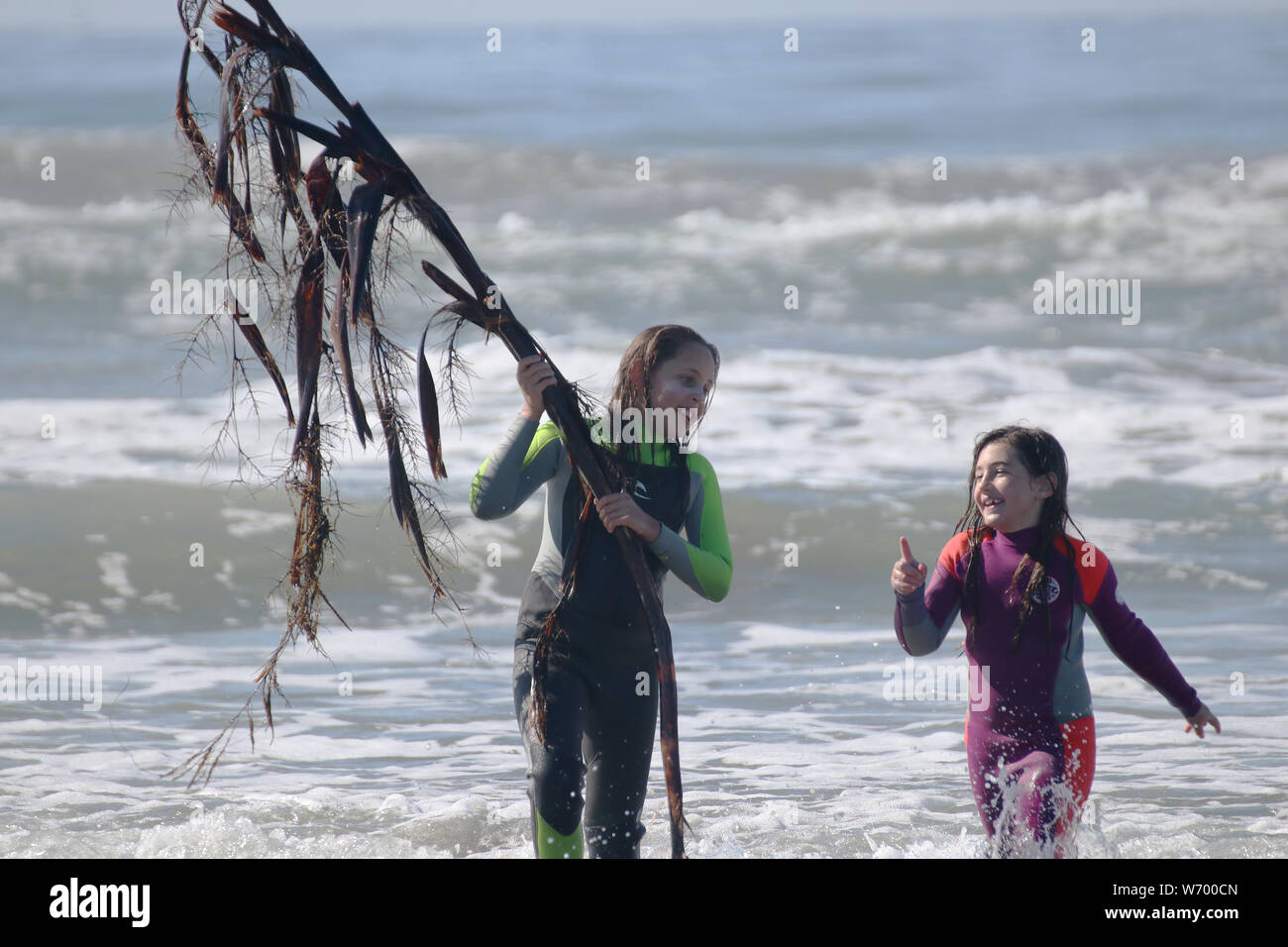 Kids surfing and beach fun Stock Photo - Alamy