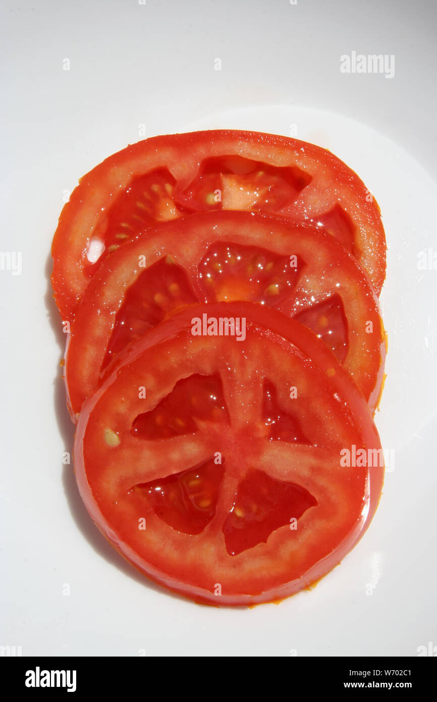 Sliced tomatoes. Tomato rings. Tomato slices. Fresh tomato sliced into ...