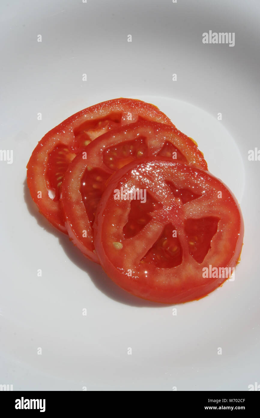 Sliced tomatoes. Tomato rings. Tomato slices. Fresh tomato sliced into ...