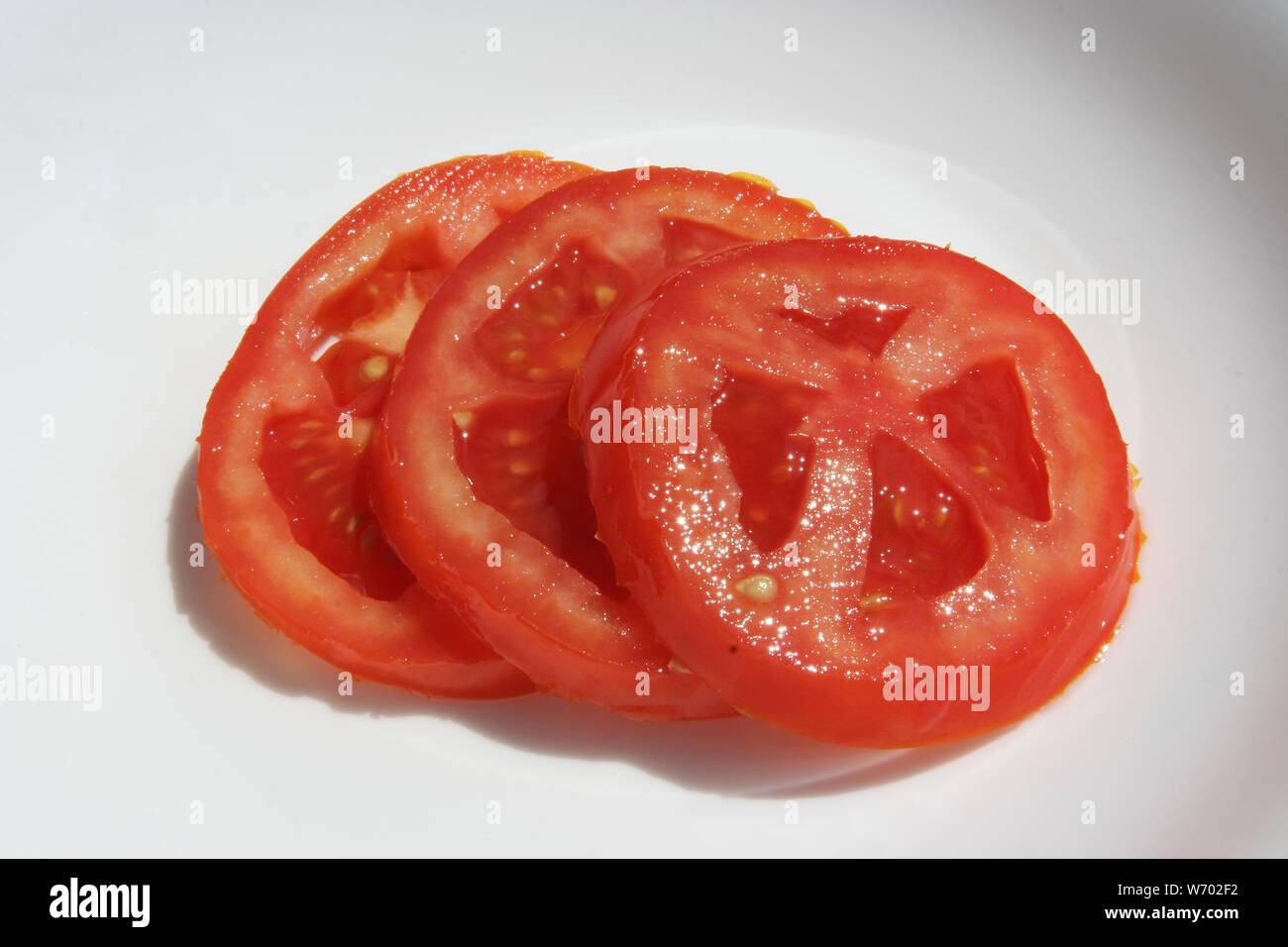 Sliced tomatoes. Tomato rings. Tomato slices. Fresh tomato sliced into ...