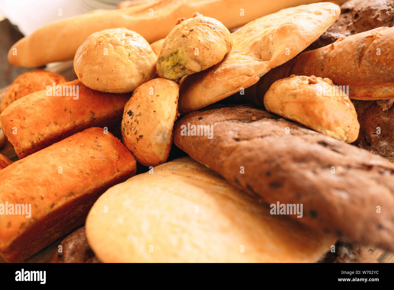 Variety of different fresh bread. Buns and loaves of bread Stock Photo ...