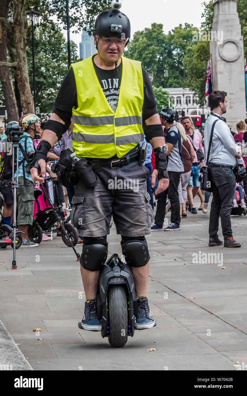London, UK. A man rides a Personal Light Electric Vehicle at tje ...