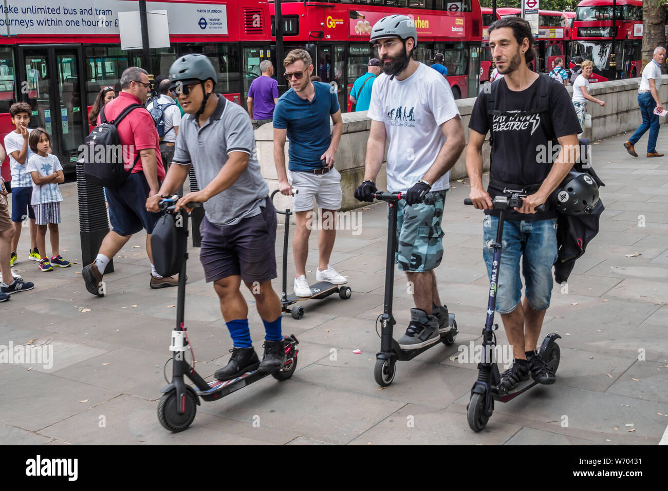 London, UK. Four electric scooter riders at the protest by users of ...