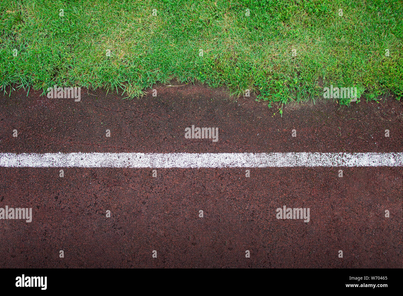 Horizontal line on red background of stadium track with grass Stock ...